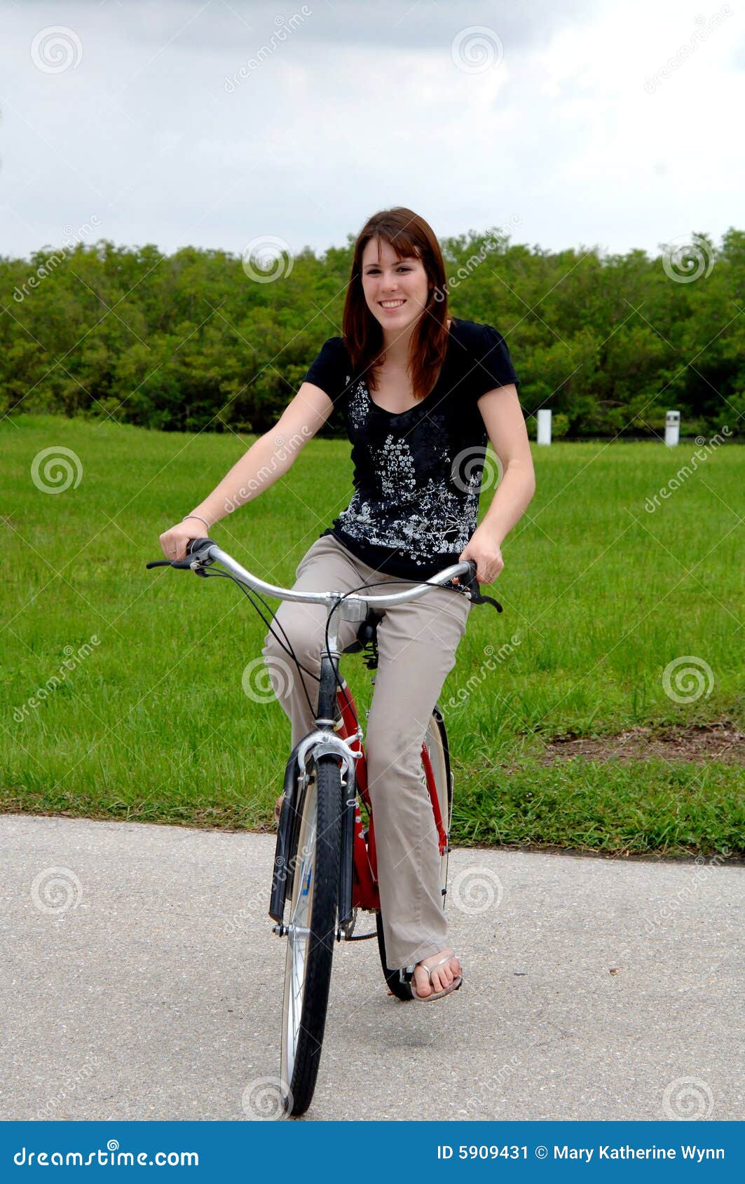 Young woman riding a bike stock image. Image of laughing - 5909431