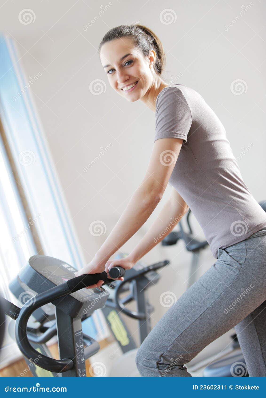 Young Woman Riding an Exercise Bike Stock Image - Image of exercise ...