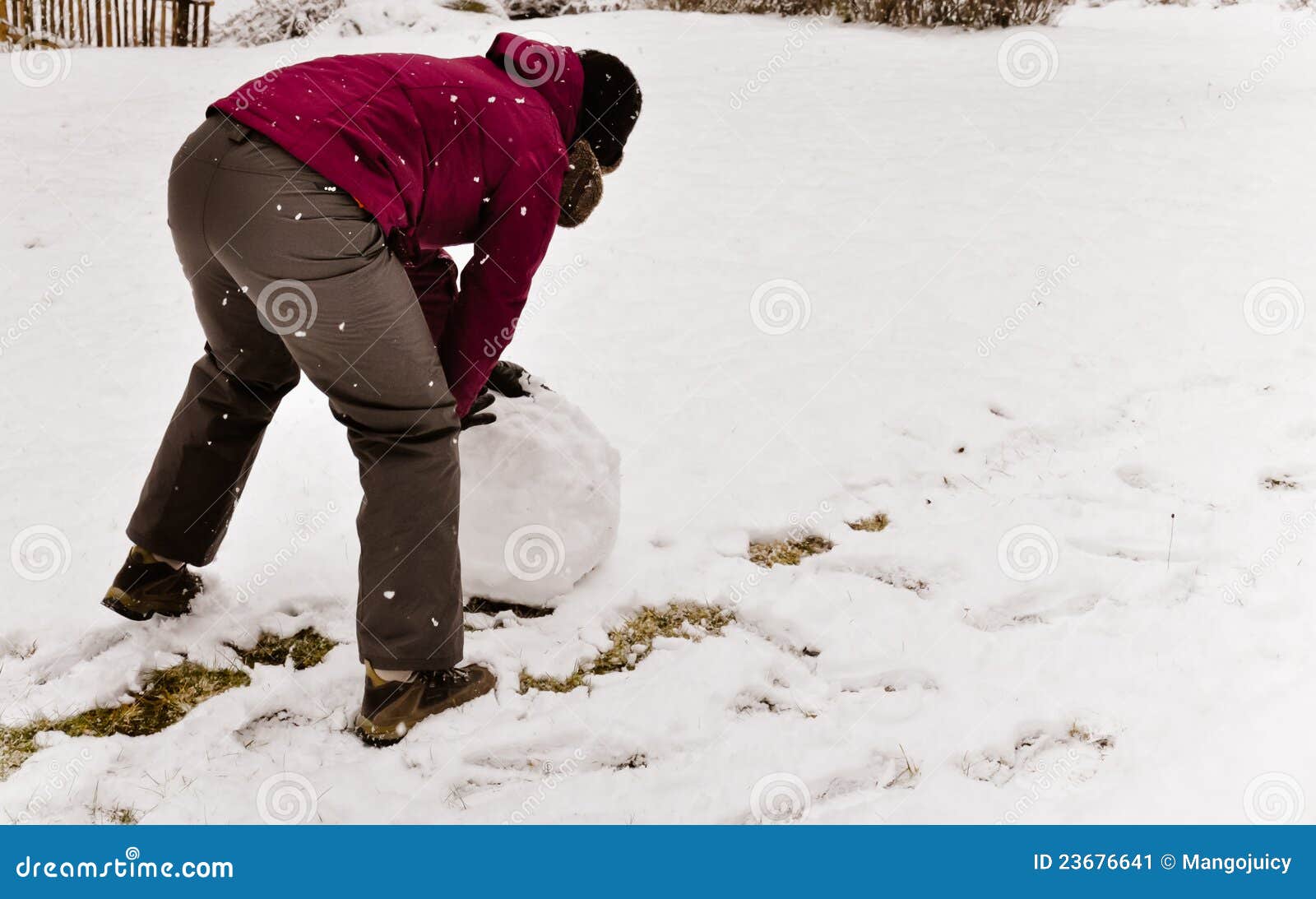 Young Woman Rolling Snowball Stock Image - Image of create, play: 23676641