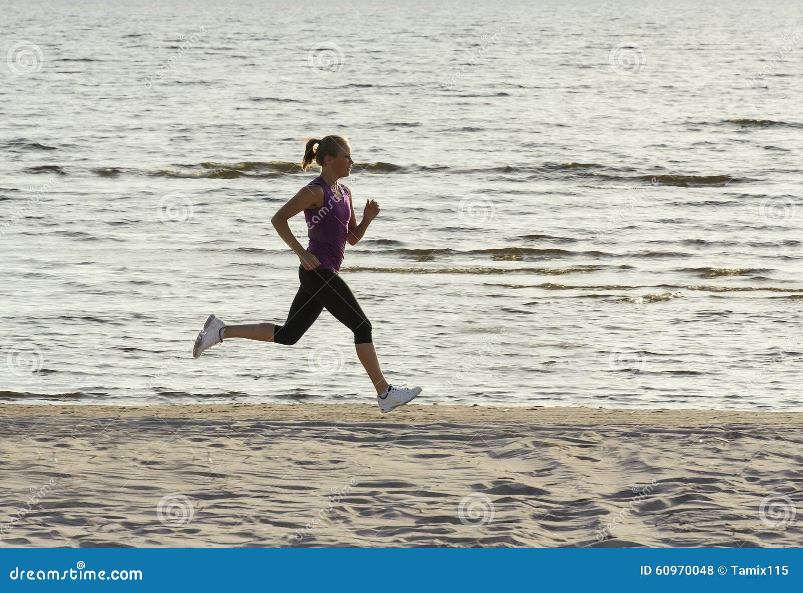 Young Woman Running Along Lake Shore Stock Photo - Image of running ...