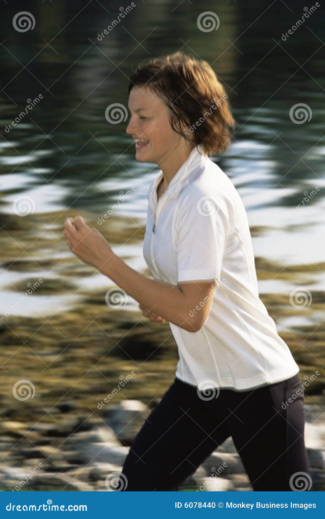 Young Woman Running Along Water S Edge Stock Photo - Image of rocks ...