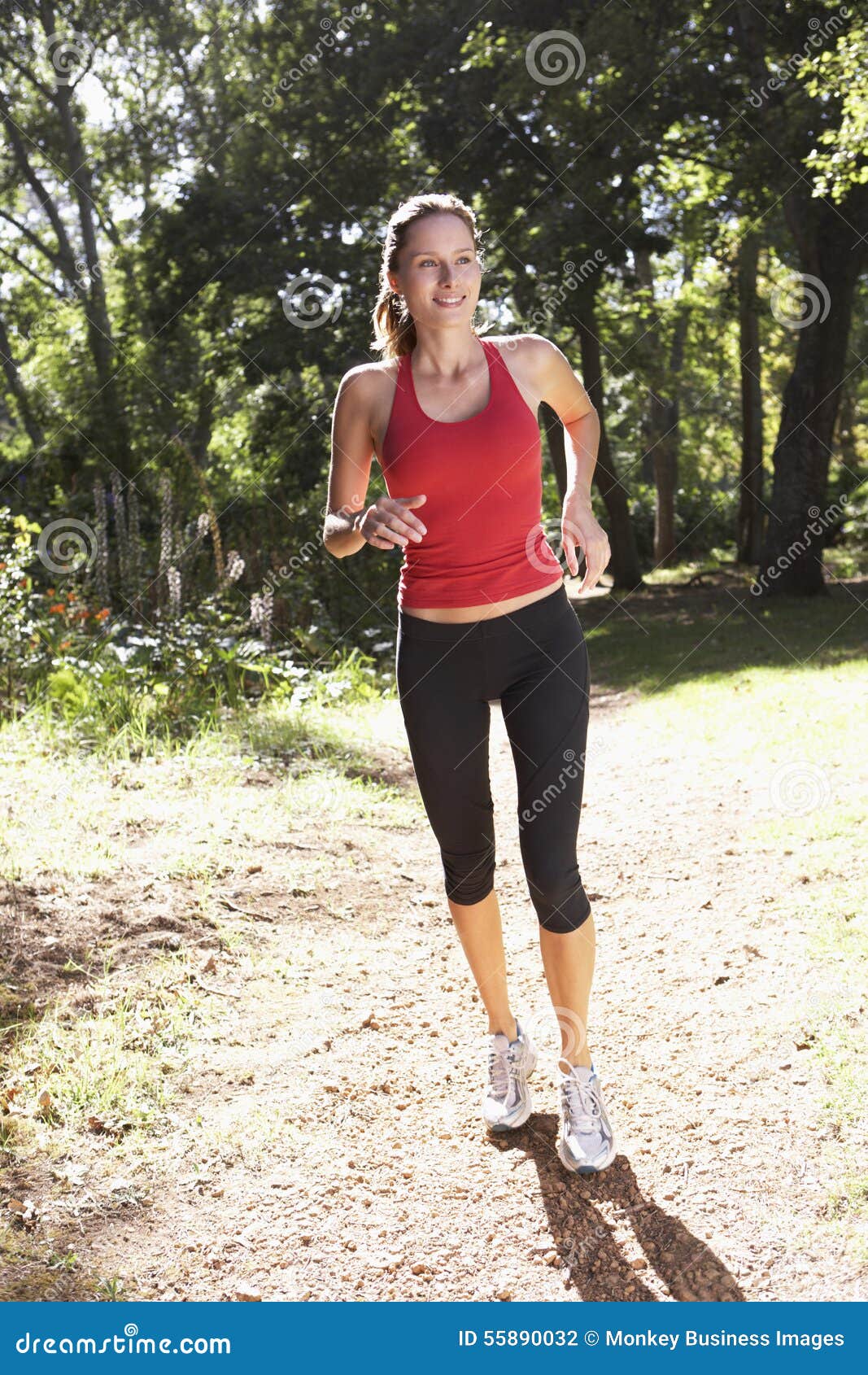 Young Woman Running Along Woodland Path Stock Photo - Image of enjoying ...