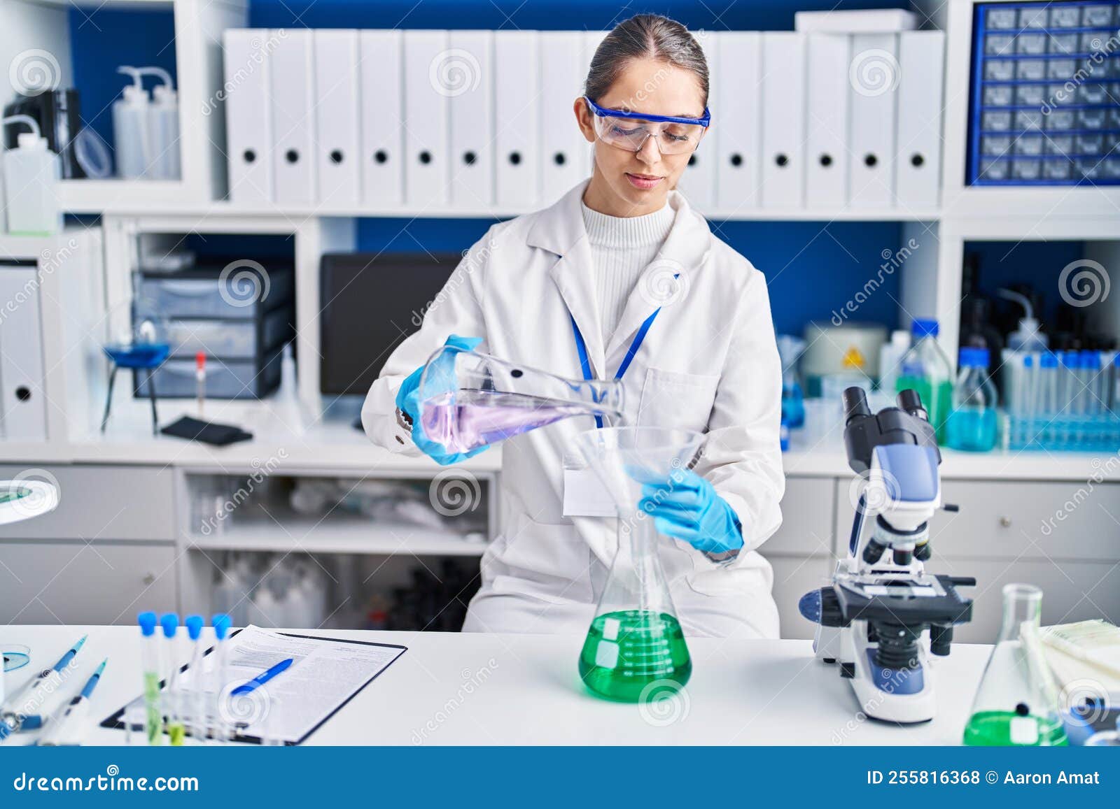 Young Woman Scientist Measuring Liquid at Laboratory Stock Photo ...