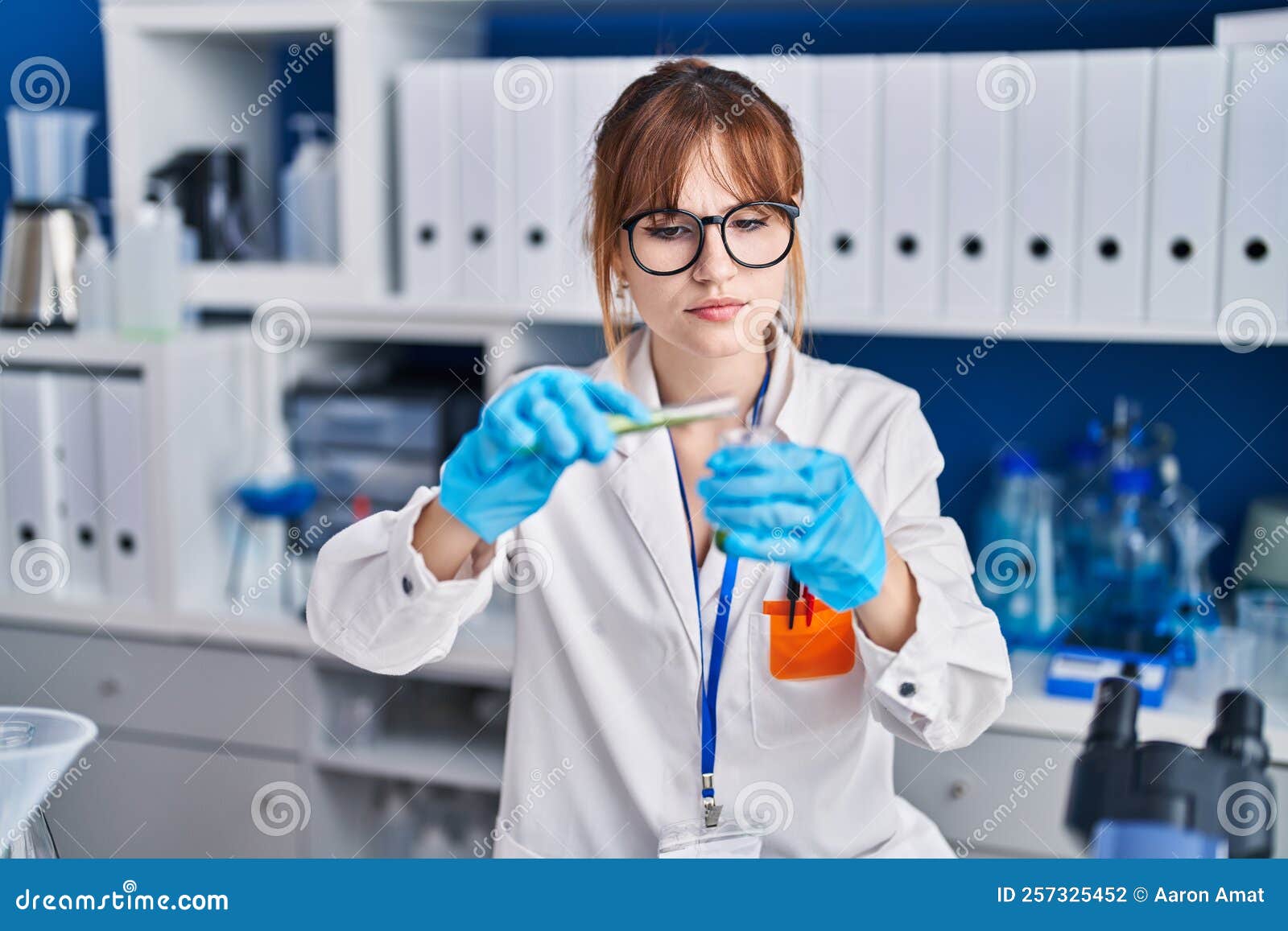 Young Woman Scientist Measuring Liquid at Laboratory Stock Photo ...