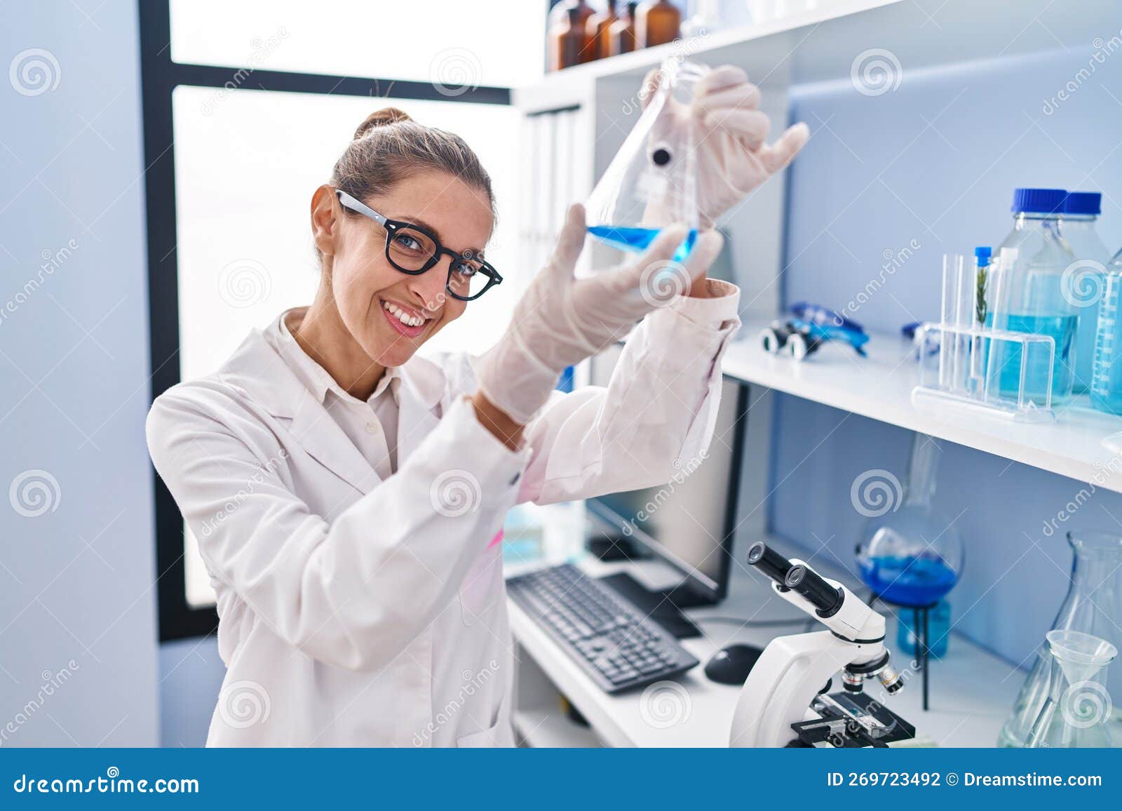 Young Woman Scientist Measuring Liquid at Laboratory Stock Photo ...