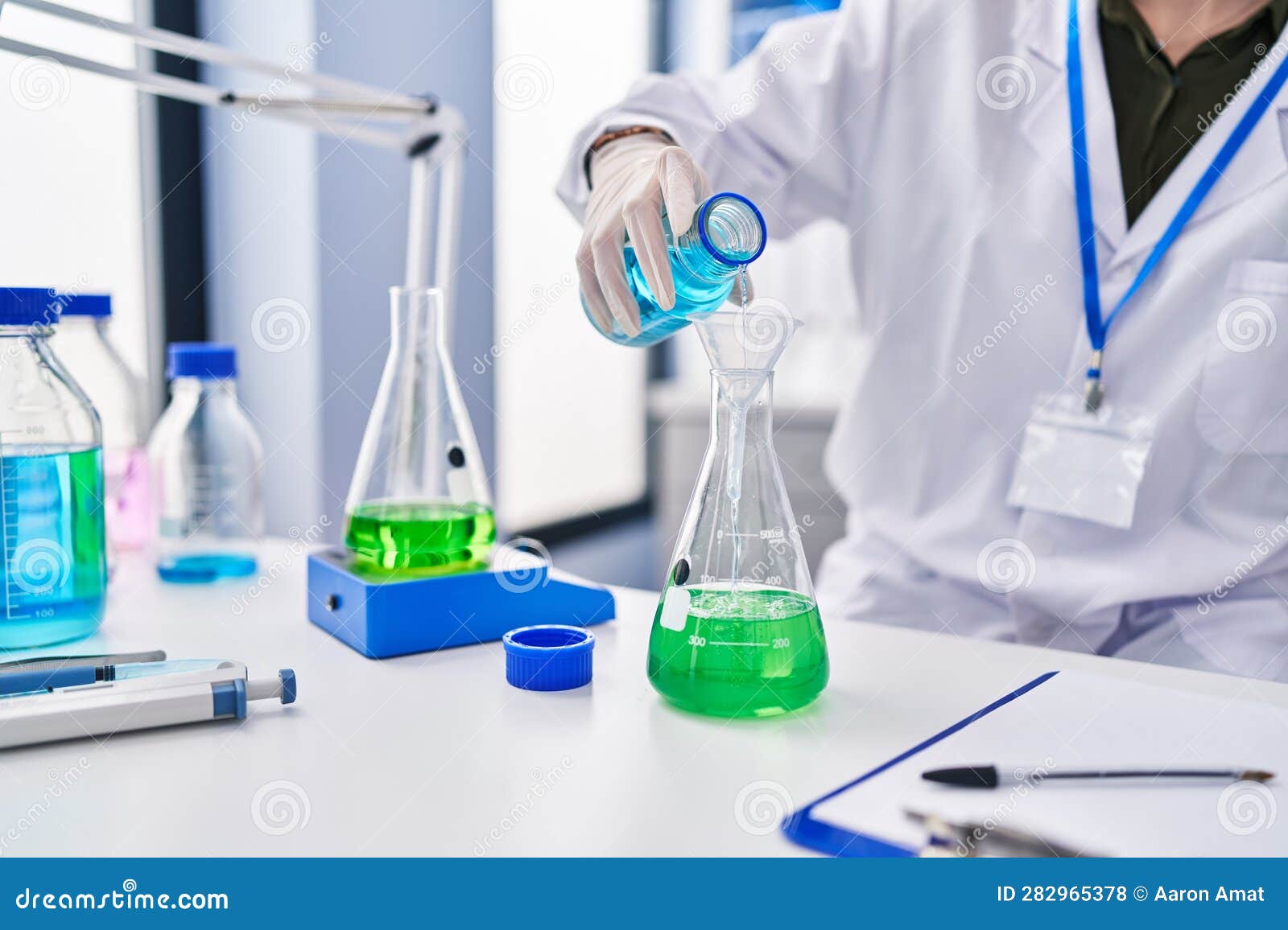 Young Woman Scientist Measuring Liquid at Laboratory Stock Photo ...