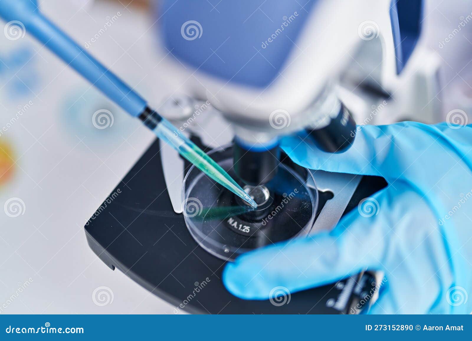 Young Woman Scientist Pouring Liquid on Sample Using Microscope at ...