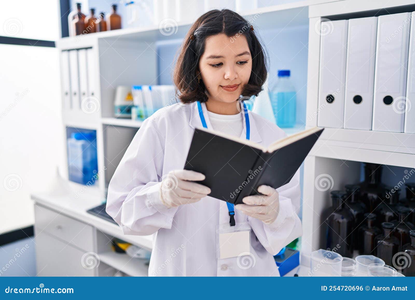 Young Woman Scientist Reading Book at Laboratory Stock Photo - Image of ...