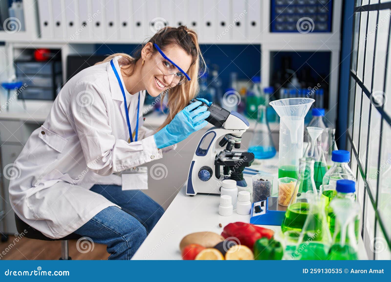 Young Woman Scientist Smiling Confident Using Microscope at Laboratory ...