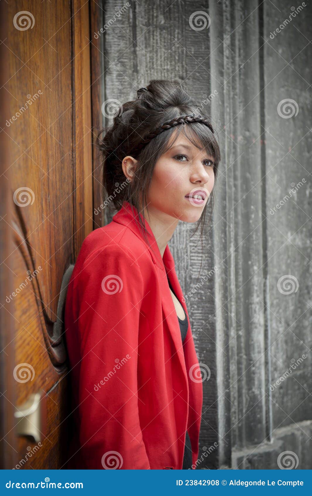 Young Woman Seated Against a Door Stock Photo - Image of caucasian ...