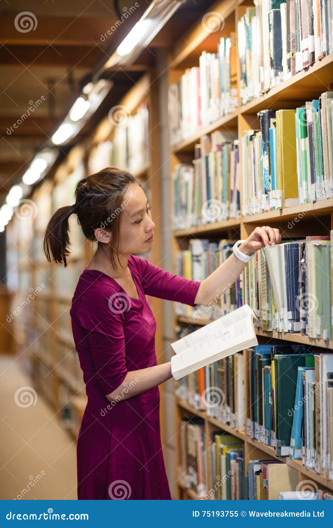 Young Woman Selecting Book in Library Stock Image - Image of book ...