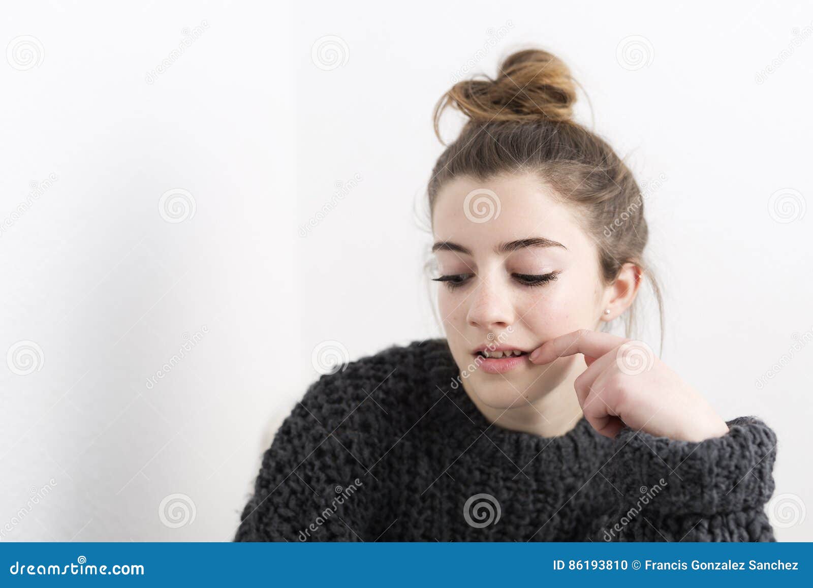 Young Woman with Serious Face on a White Background. Stock Photo ...