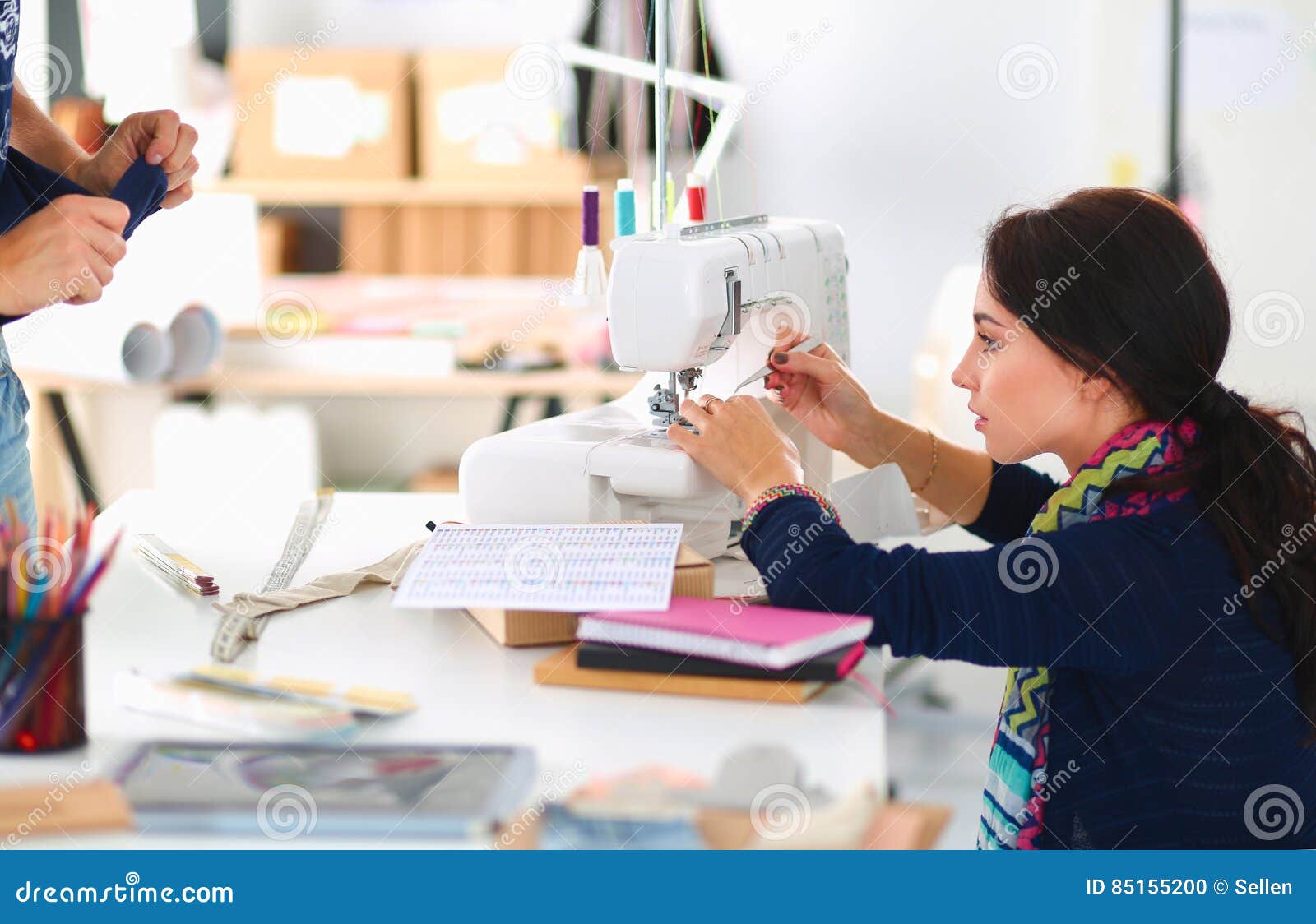 Young Woman Sewing while Sitting at Her Working Place Stock Photo ...