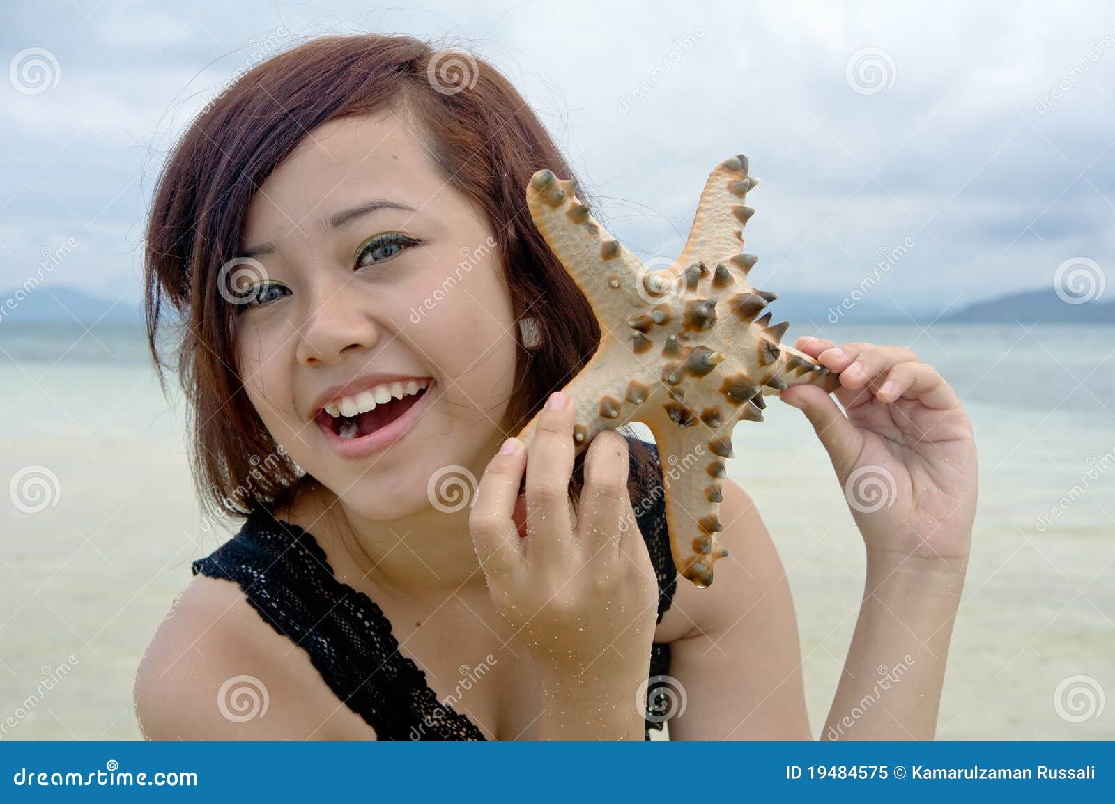 Young woman shows starfish stock image. Image of holiday - 19484575