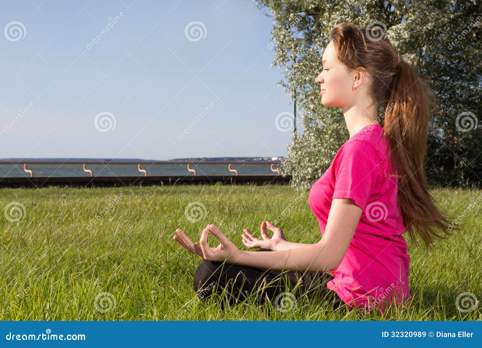 Young Woman Siiting on the Grass in Yoga Pose Stock Image - Image of ...