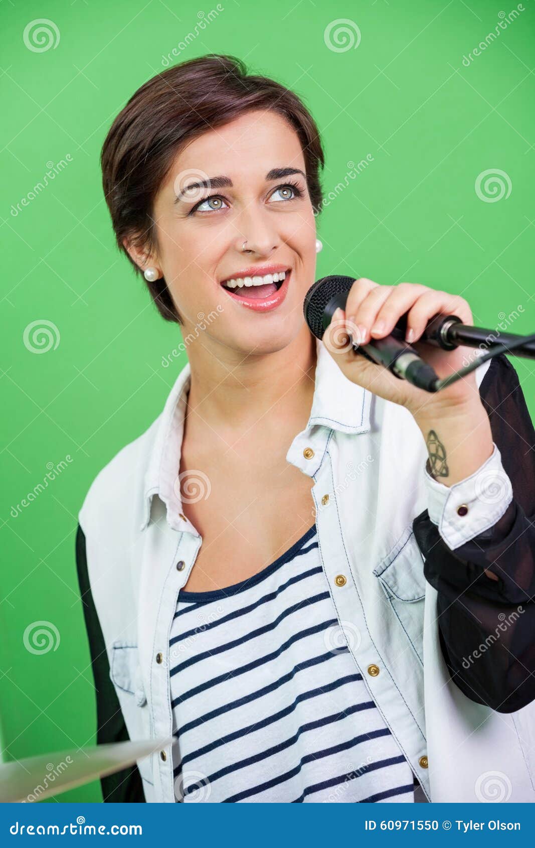 Young Woman Singing while Holding Microphone Stock Photo - Image of ...