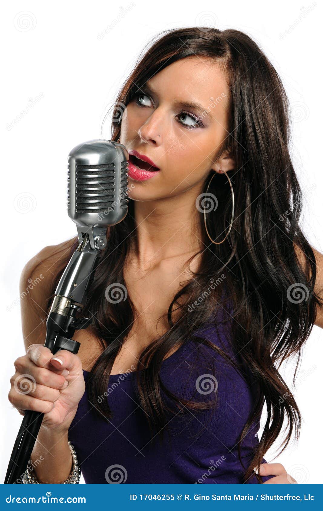 Young Woman Singing into a Microphone Stock Image - Image of woman ...