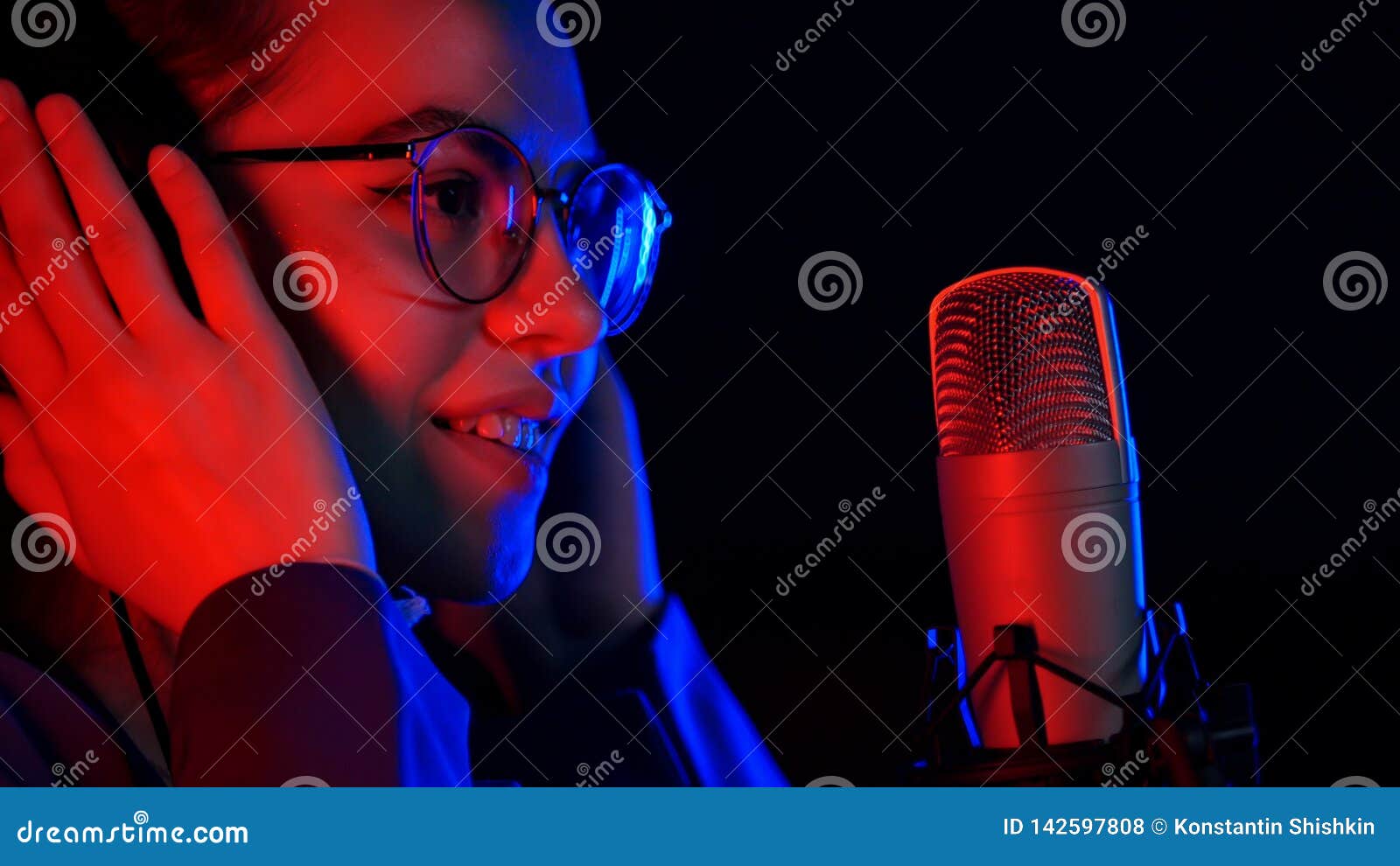 A Young Woman Singing in Neon Lighting in the Studio Stock Photo ...