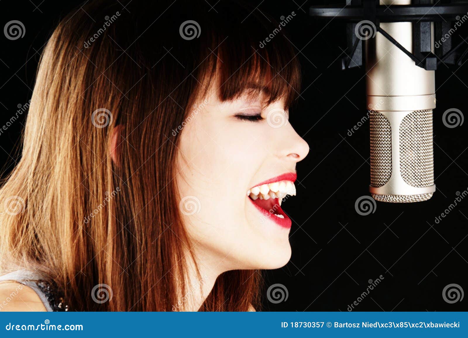 Young Woman Singing To the Microphone in a Studio Stock Image - Image ...