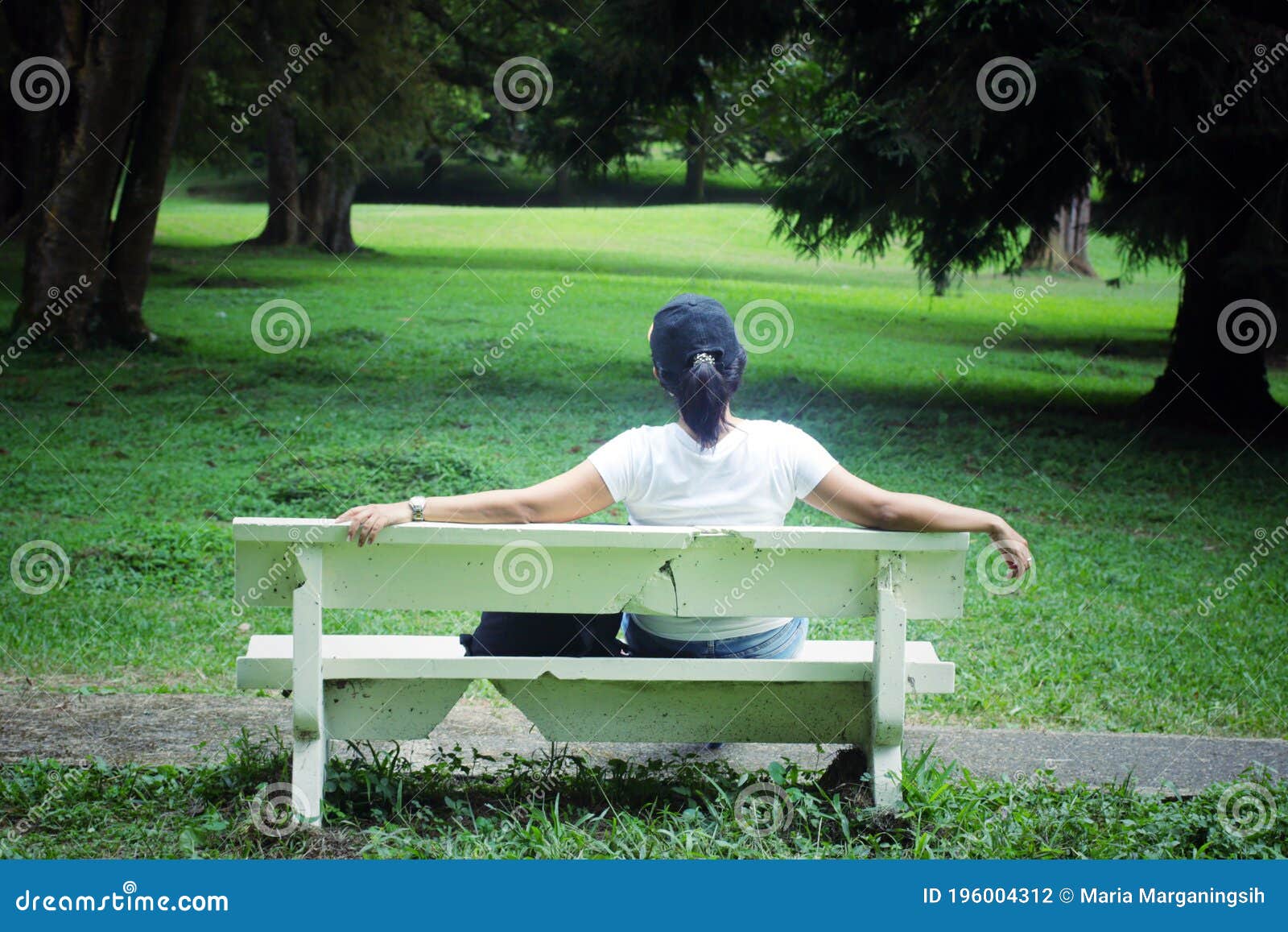 Young Woman Sitting Alone on a Bench in the Green Park. Stock Photo ...