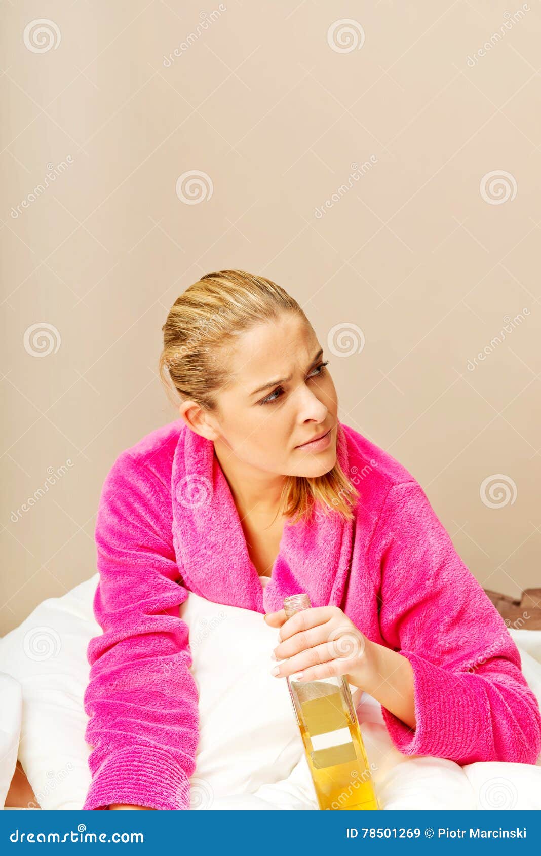 Young Woman Sitting on the Bed Crying and Drinking Whiskey Stock Image ...
