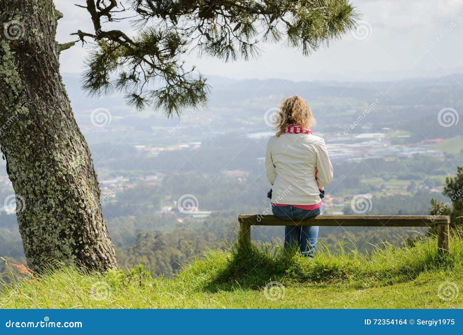 Young Woman Sitting on a Bench Looking at the Nature Stock Photo ...