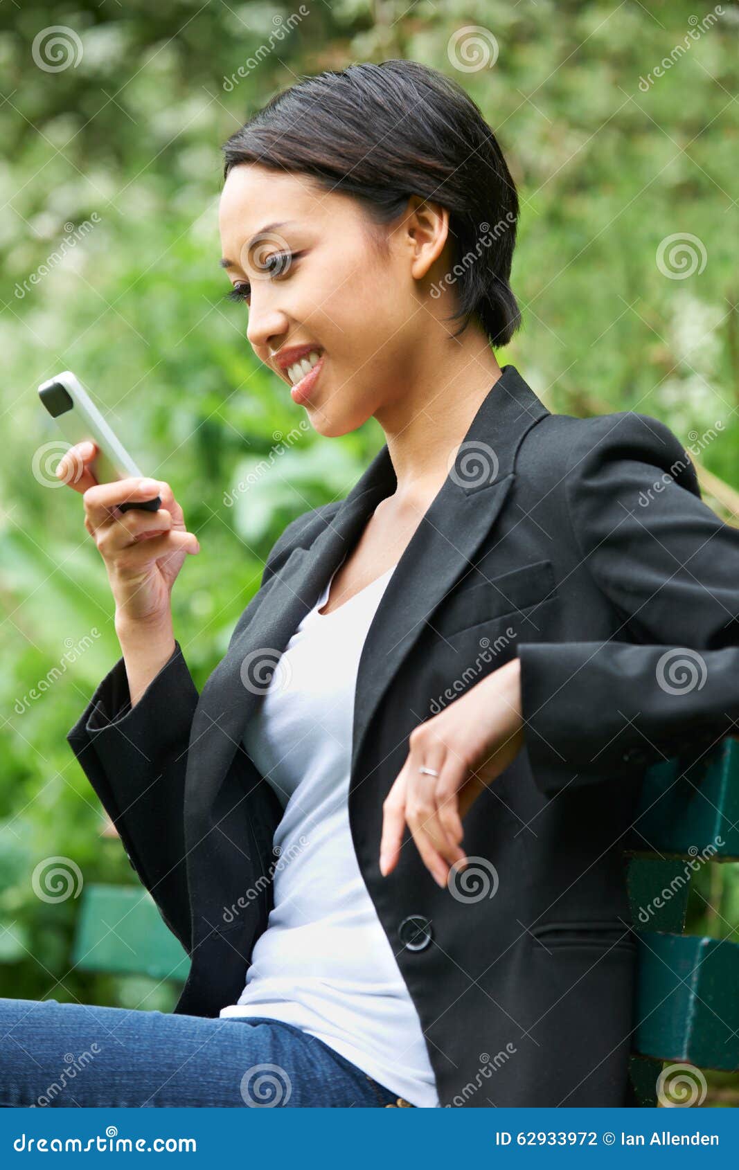 Young Woman Sitting on Bench Reading Text Message Stock Photo - Image ...