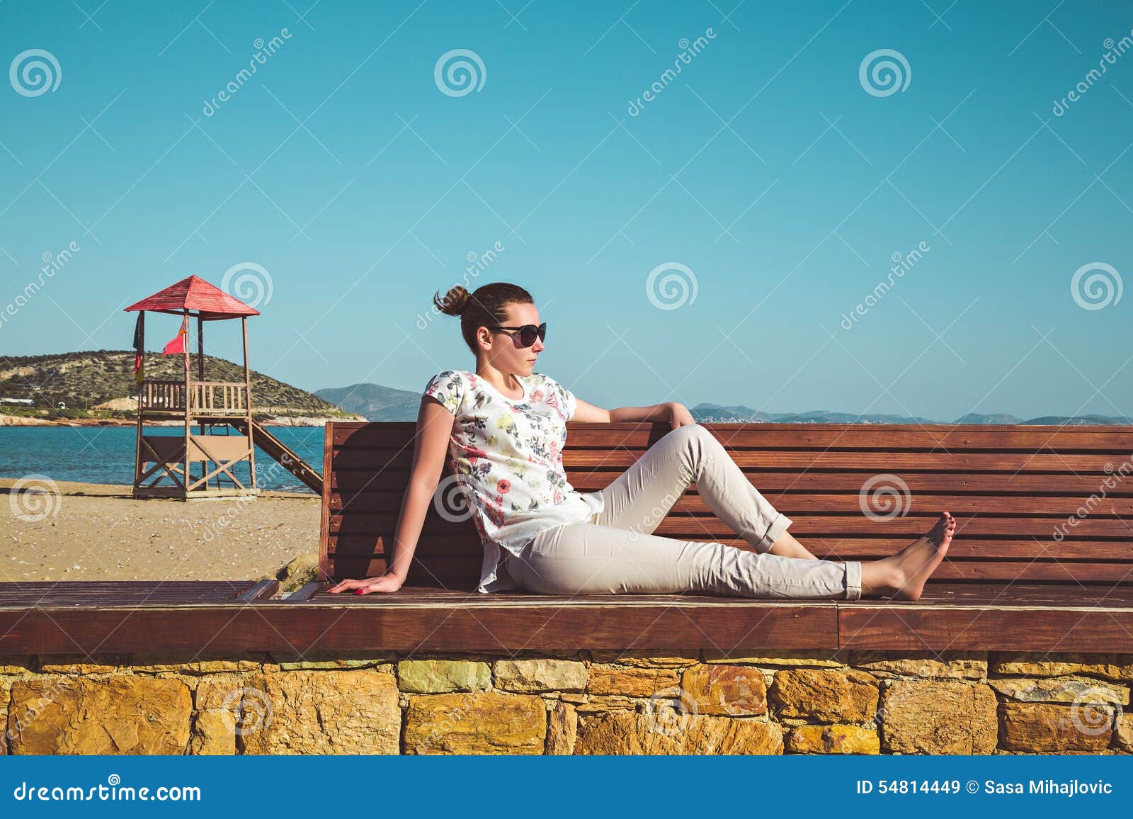 Young Woman Sitting on a Bench and Sun Tanning Stock Image - Image of ...