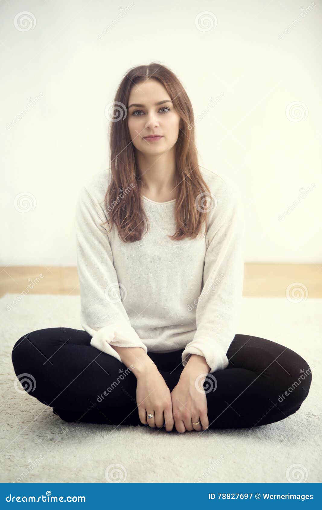 Young Woman Sitting on Carpet and Looking at Camera Stock Image - Image ...