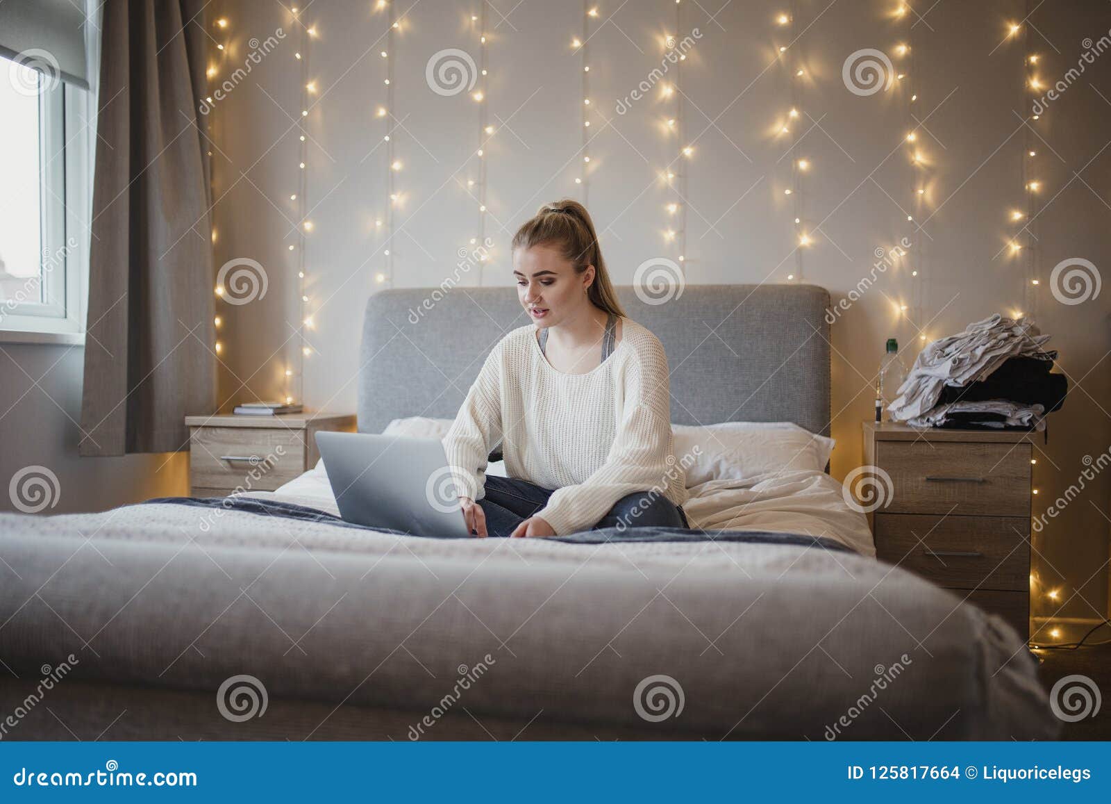 Student Using Laptop in Bedroom Stock Photo - Image of double, adult ...