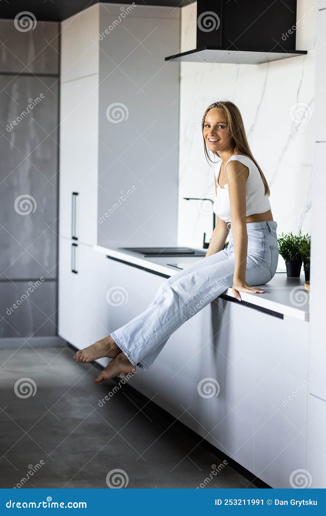 Young Pretty Woman Sitting on the Kitchen Counter Stock Image - Image ...