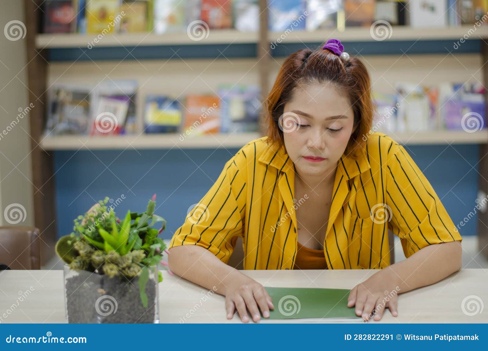 Young Woman Sitting in the Library Reading a Book Stock Image - Image ...