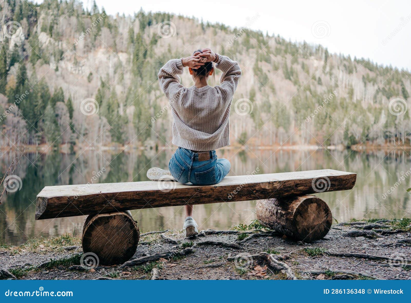 Young Woman Sitting on a Log in an Outdoor Setting. Stock Photo - Image ...