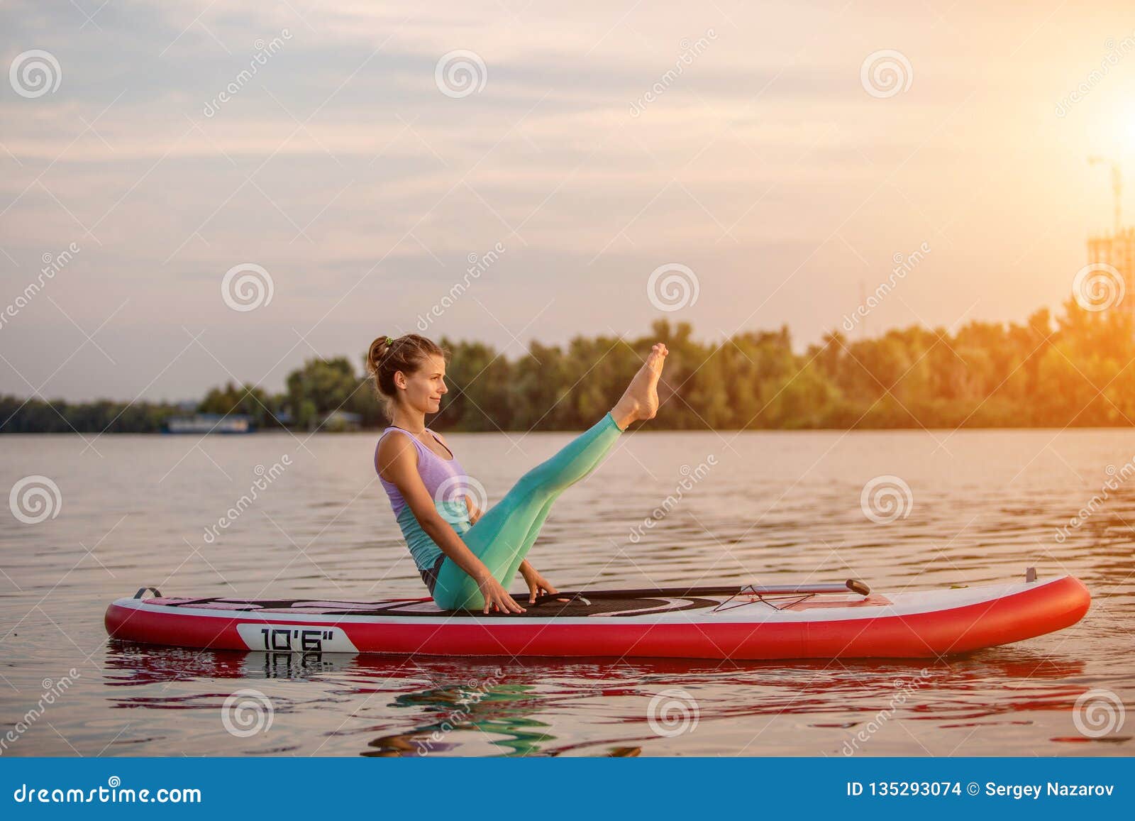 Young Woman Sitting on Paddle Board, Practicing Yoga Pose. Doing Yoga ...