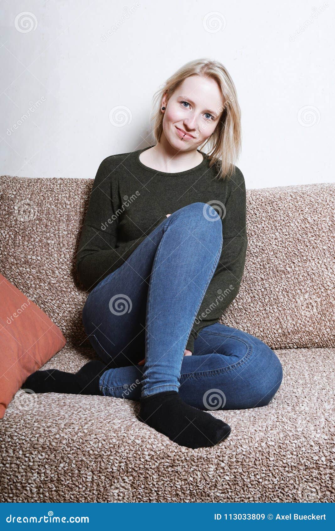 Young Woman Sitting on Sofa at Home Stock Image - Image of person ... Young Woman Sitting on Sofa at Home Stock Image - Image of person ...