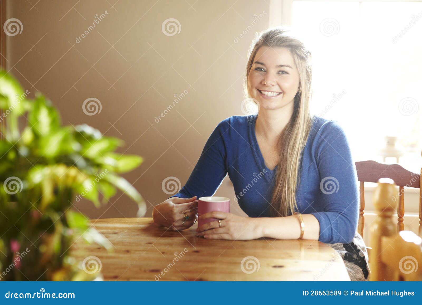 Young Woman Sitting at Table Smiling Stock Image - Image of joyfulness ... Young Woman Sitting at Table Smiling Stock Image - Image of joyfulness ...