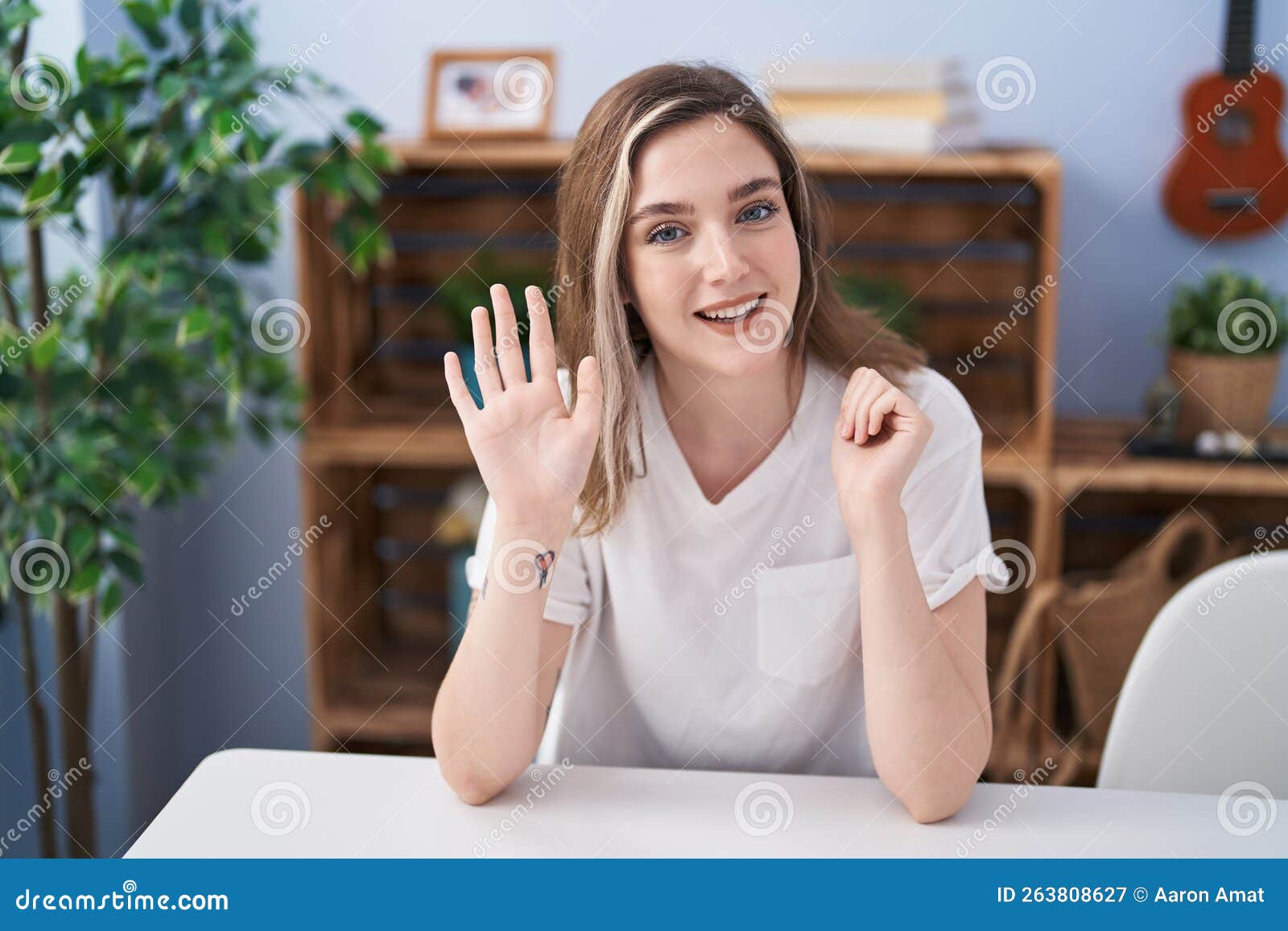 Young Woman Sitting on Table Speaking at Home Stock Image - Image of ...