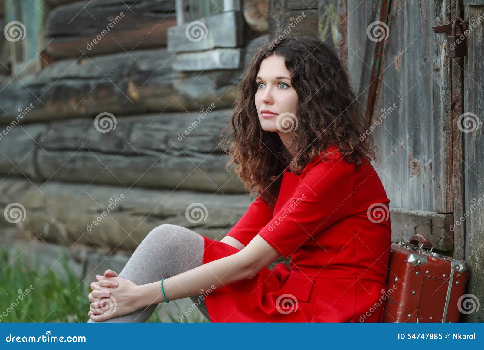 Young Woman Sitting on Threshold of Old Log Cabin with Retro Suitcase ...