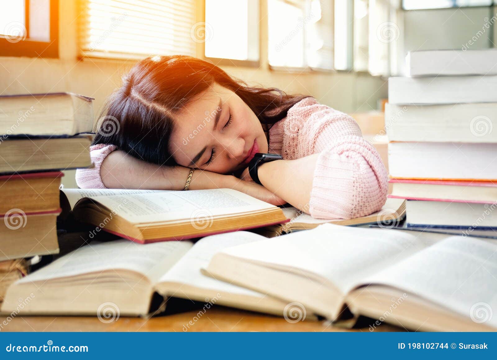 Young Woman Sleeping in Library Stock Photo - Image of background ...