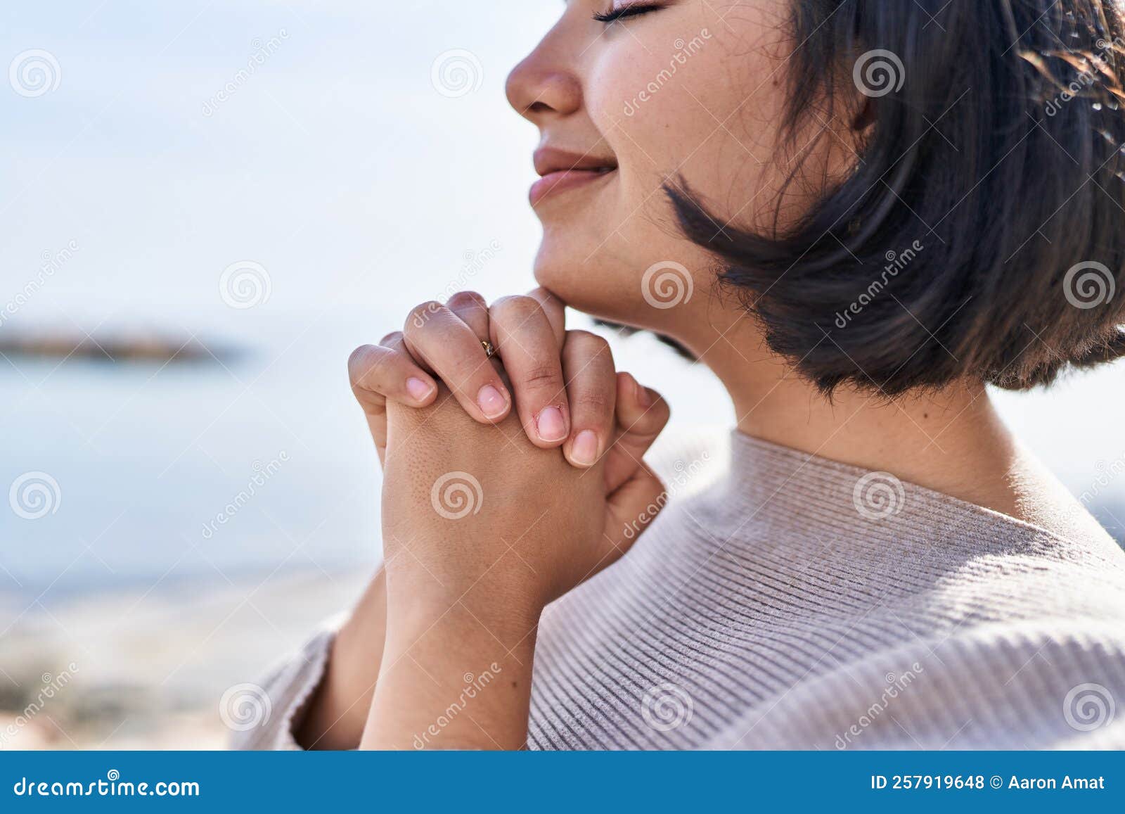 Young Woman Smiling Confident Praying at Seaside Stock Photo - Image of ...
