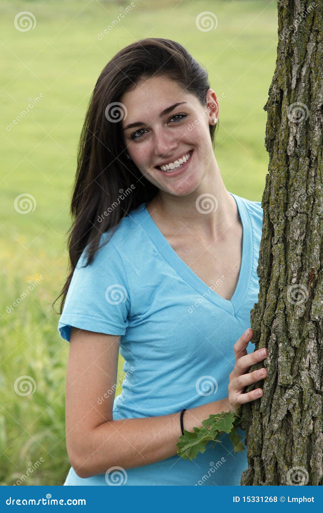 Young Woman Smiling beside a Tree Stock Photo - Image of outdoor ...