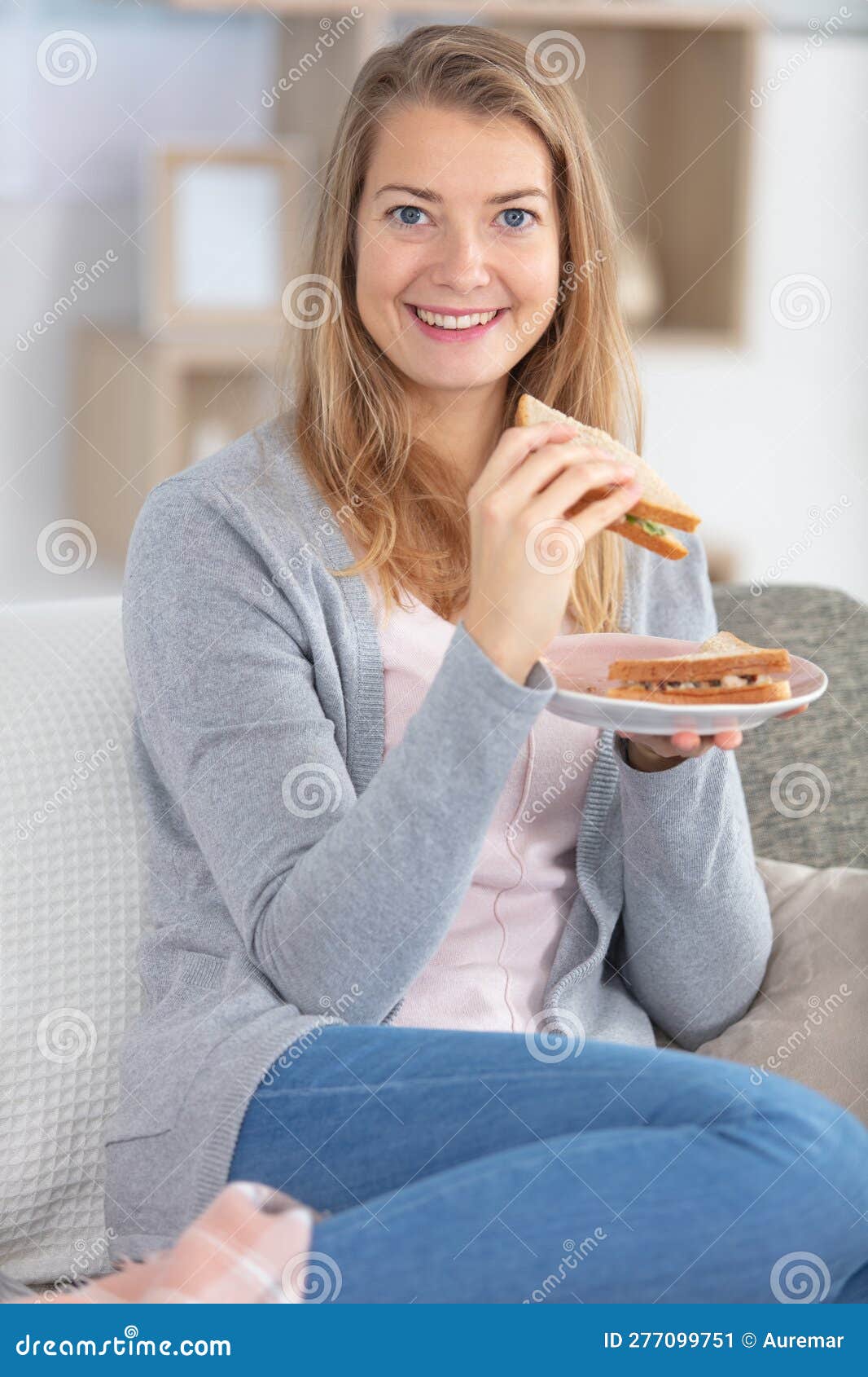 Young Woman on Sofa Eating Sandwich Stock Image - Image of bread, young ...