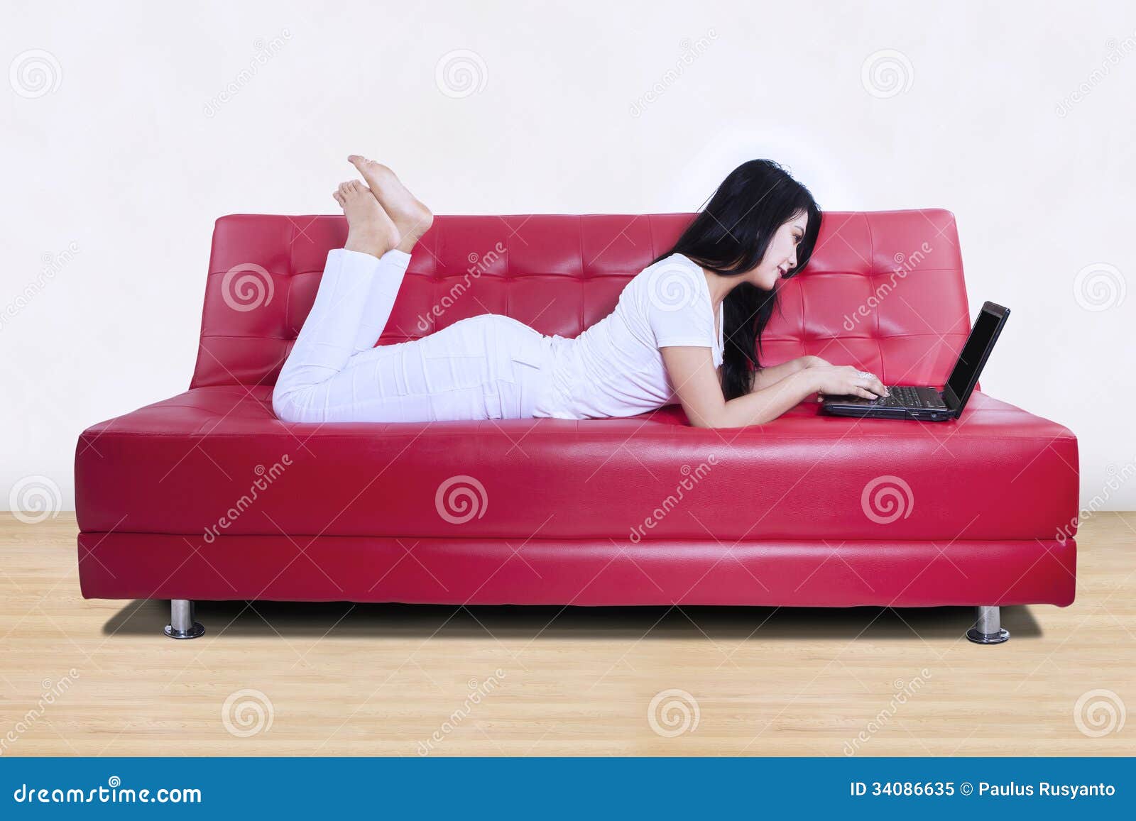 Young Woman on a Sofa Working with a Laptop Stock Image - Image of ...
