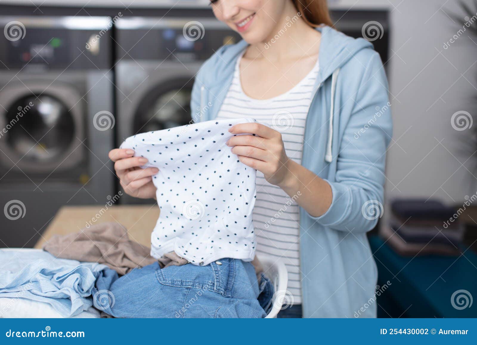 Young Woman Sorting Laundry in Laundromat Stock Photo - Image of female ...