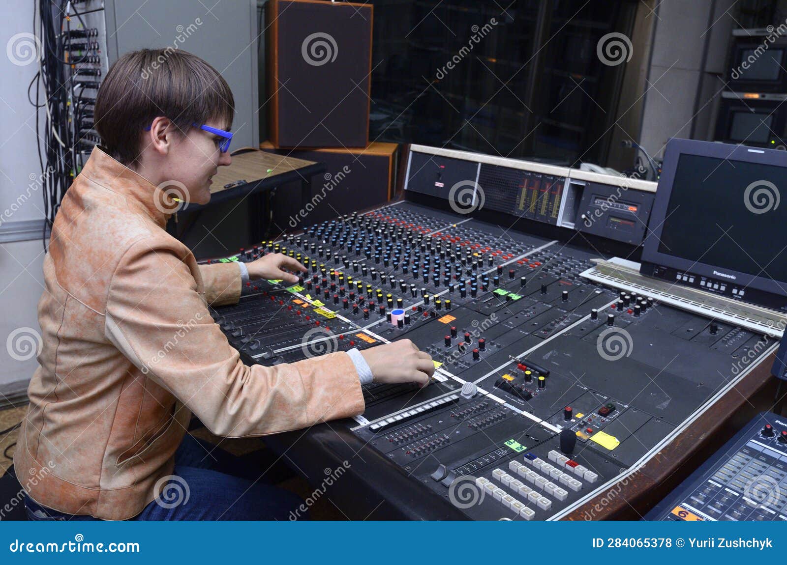 Young Woman Sound Engineer Working with a Mixer Control Panel at the TV ...