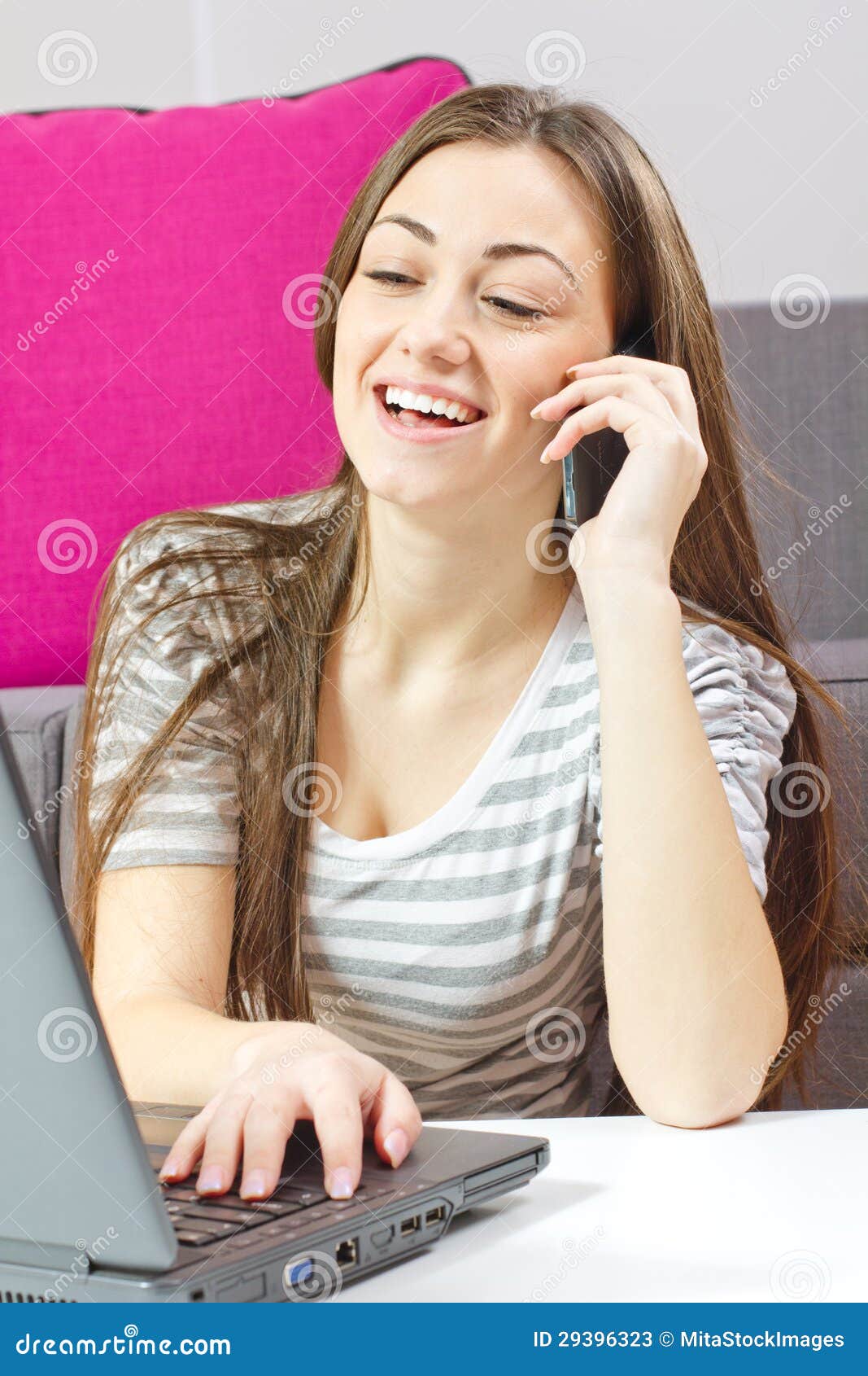Young Woman Speaking by Phone and Using Laptop Stock Image - Image of ...