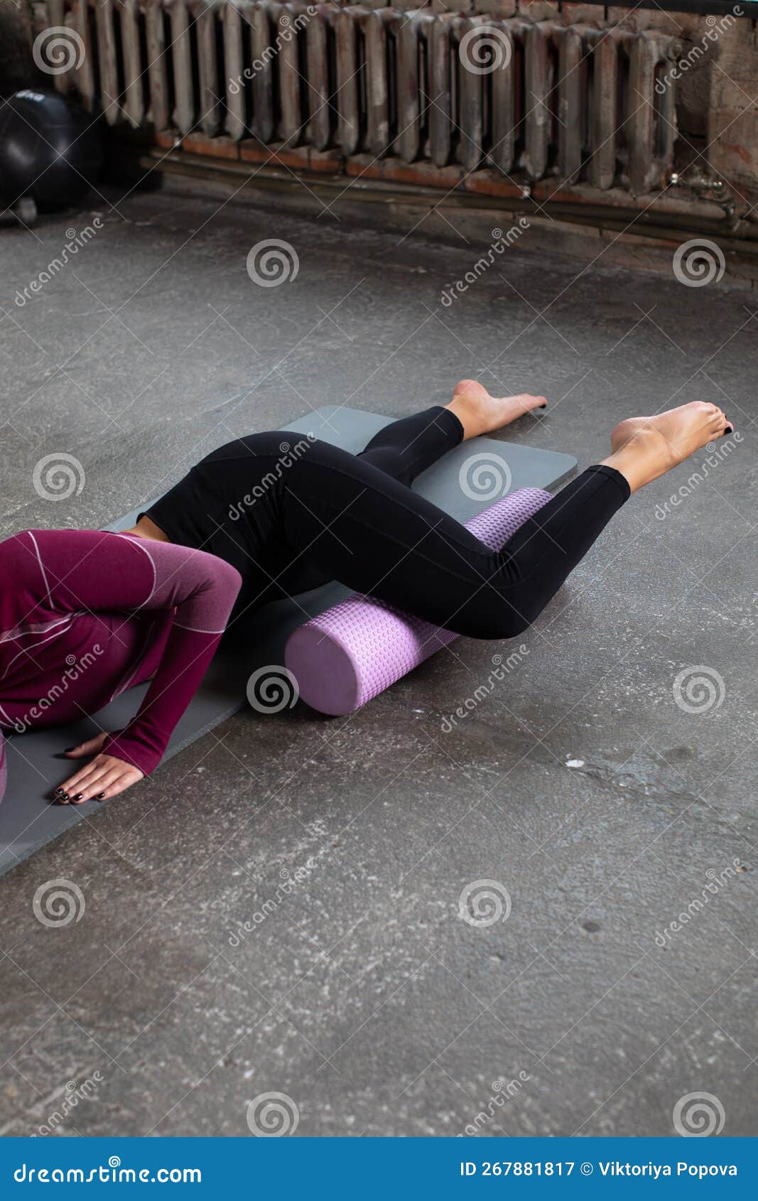A Young Woman In Sportswear Performs A Myofascial Hip Massage With A Roller Muscle Recovery
