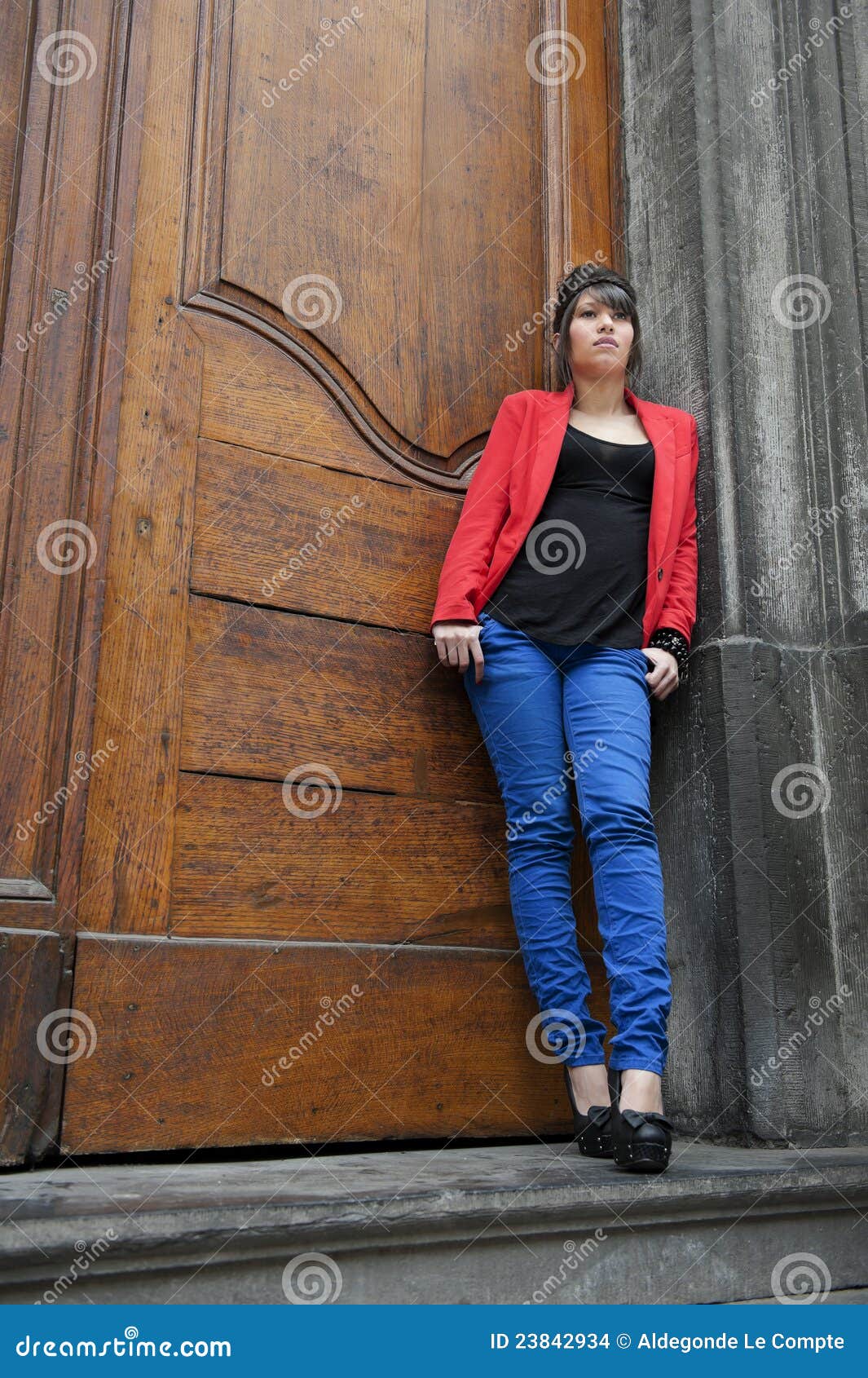 Young Woman Standing Against a Door Stock Photo - Image of people, slim ...