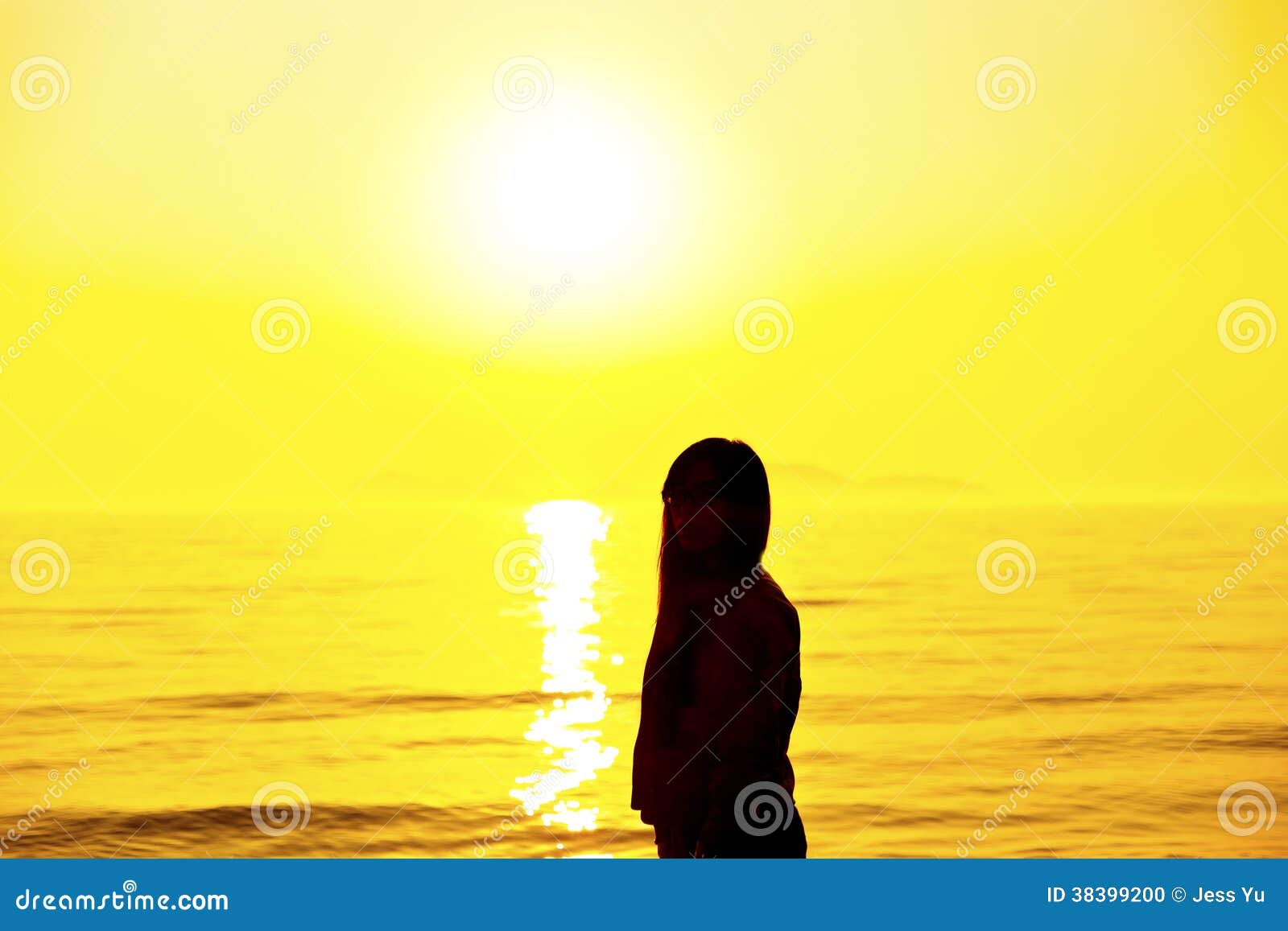 Young Woman Standing on Beach Under Sunset Light Stock Photo - Image of ...