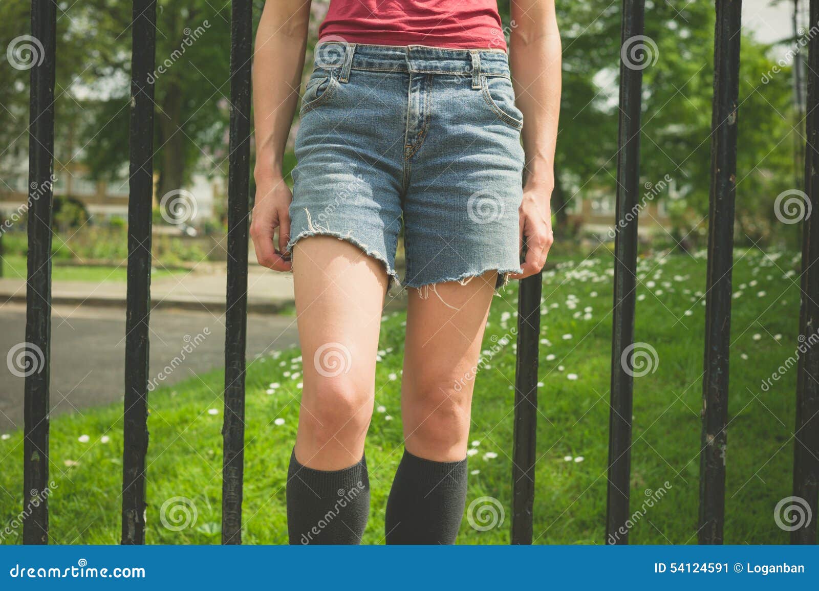 Young Woman Standing by Gate Outside Park Stock Image - Image of adult ...